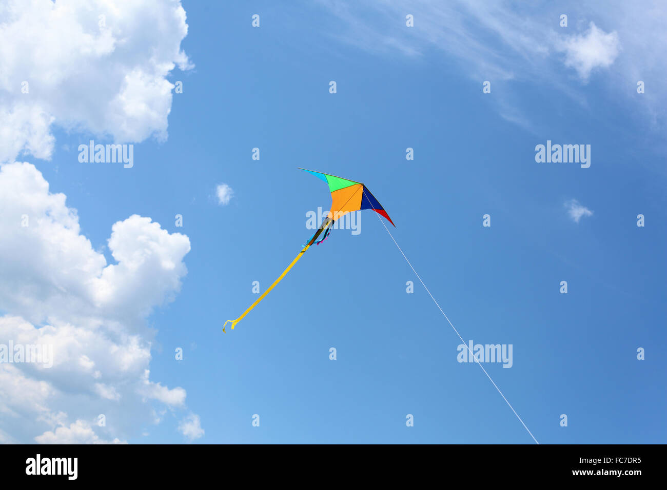 wind kite flying in the blue summer sky Stock Photo - Alamy