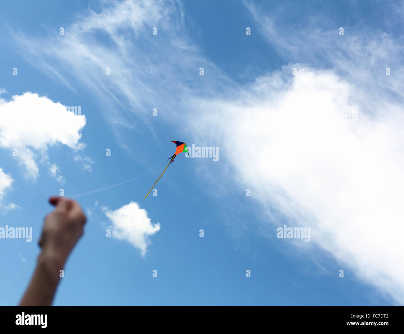 wind kite flying in the blue summer sky Stock Photo - Alamy
