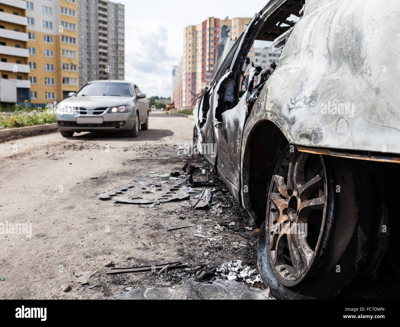 Arson fire burnt wheel car vehicle junk Stock Photo - Alamy