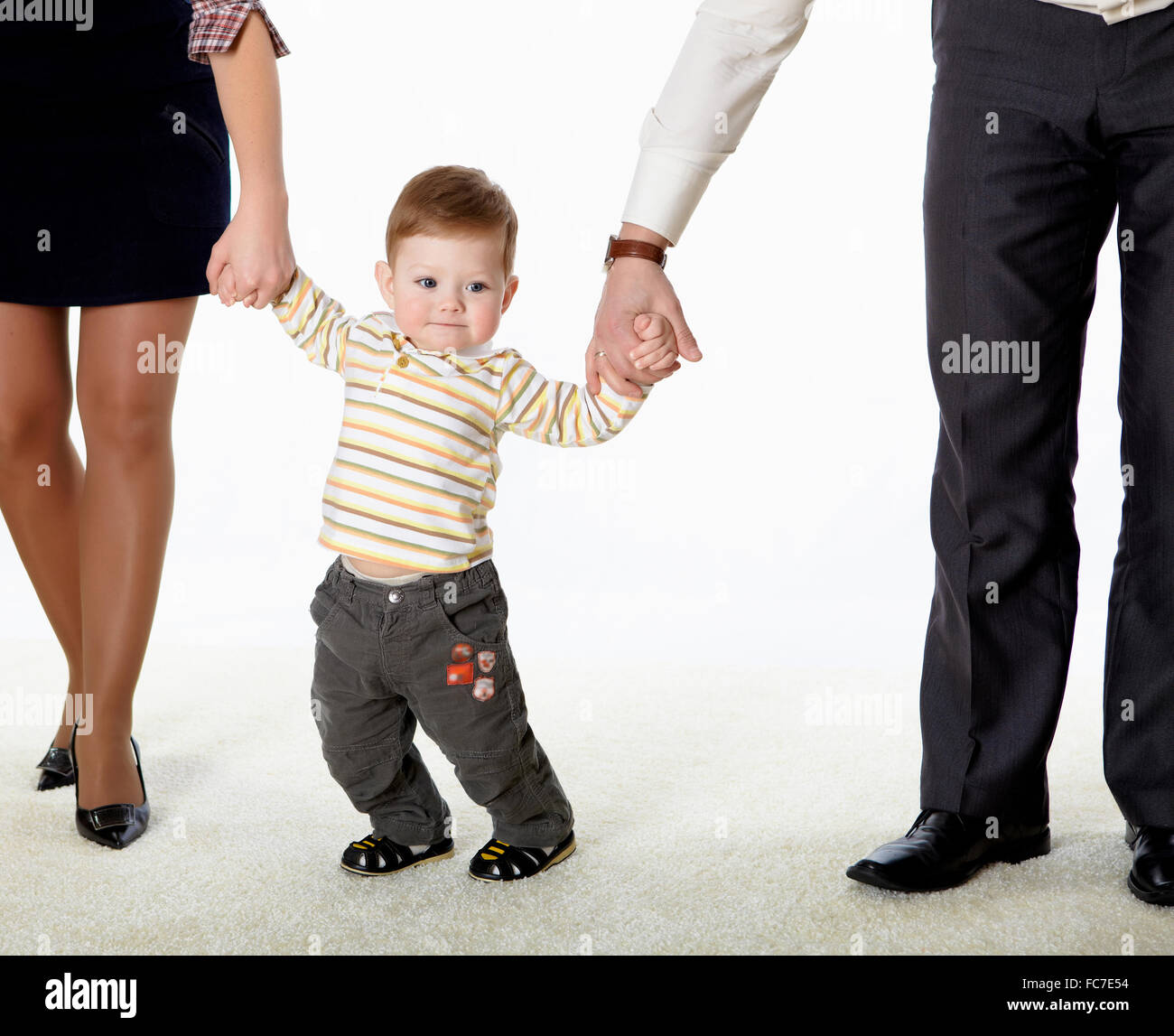 little baby learning how to walk with a parent Stock Photo - Alamy