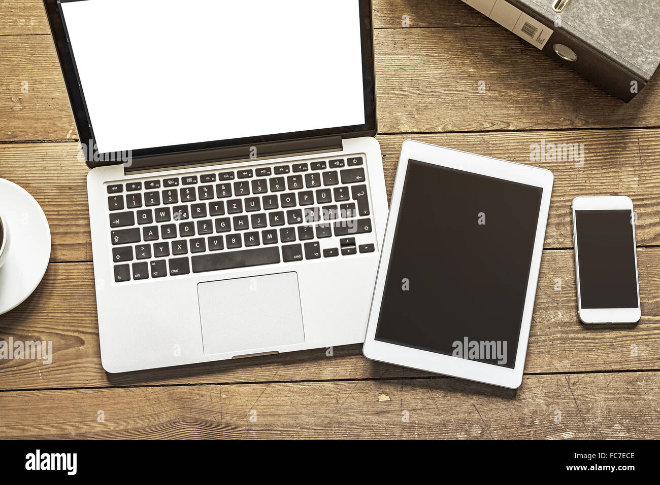 laptop tablet and phone on wooden workspace Stock Photo - Alamy