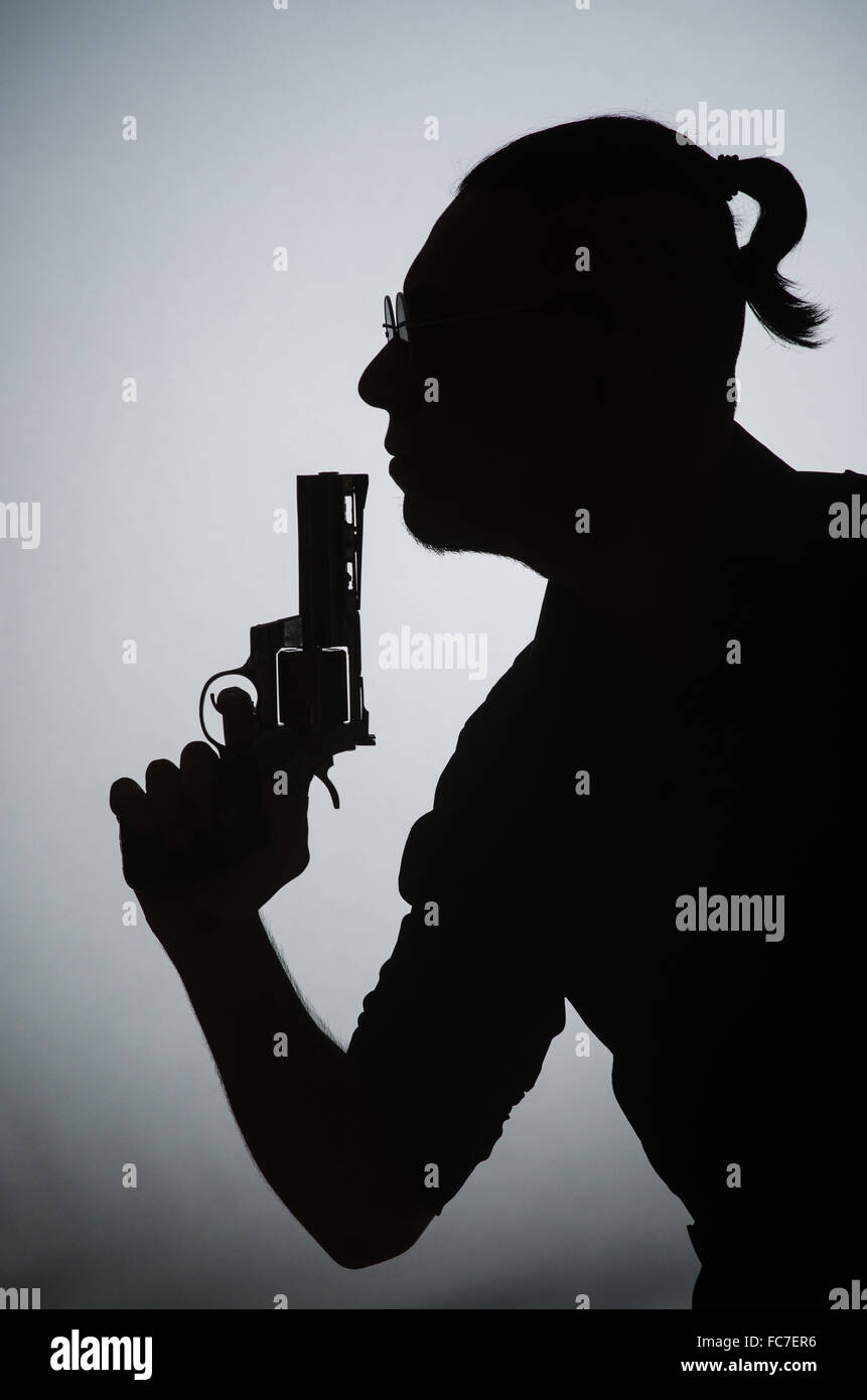Shadow of the man with gun Stock Photo - Alamy
