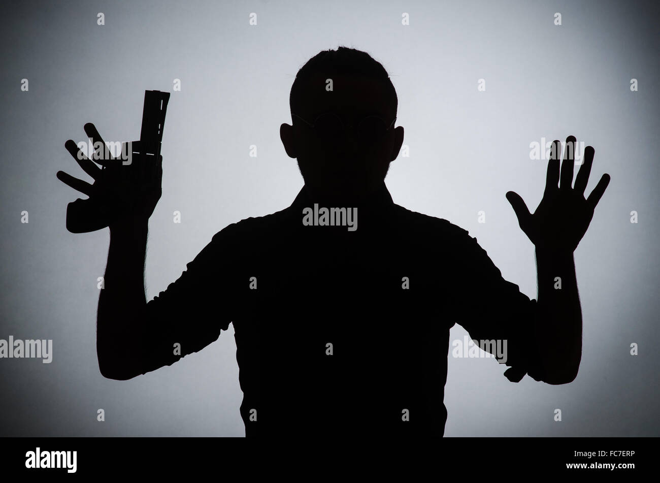 Shadow of the man with gun Stock Photo - Alamy