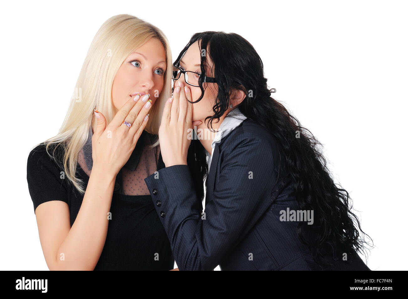 two charming business women whispering to each other Stock Photo - Alamy