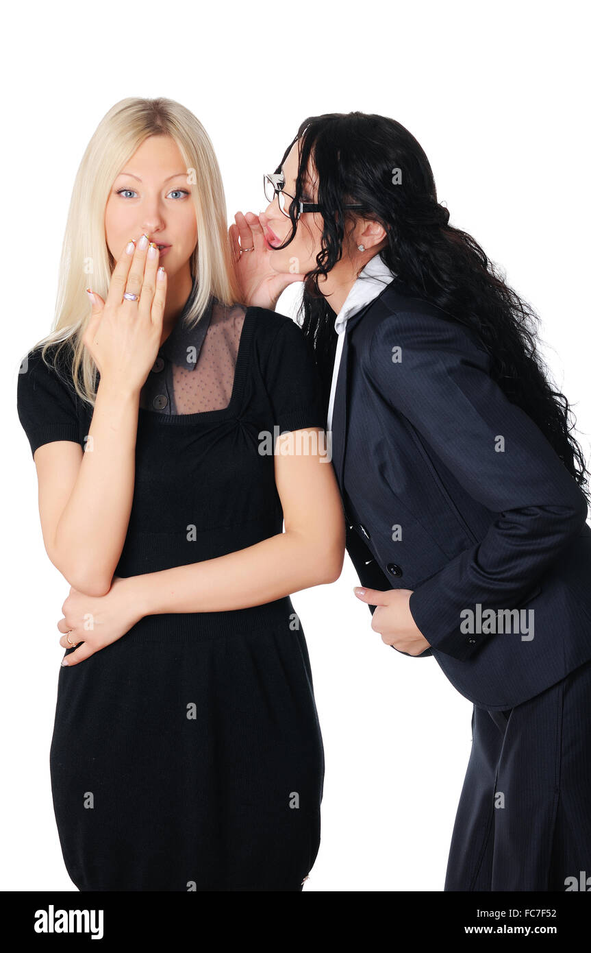 two charming business women whispering to each other Stock Photo - Alamy