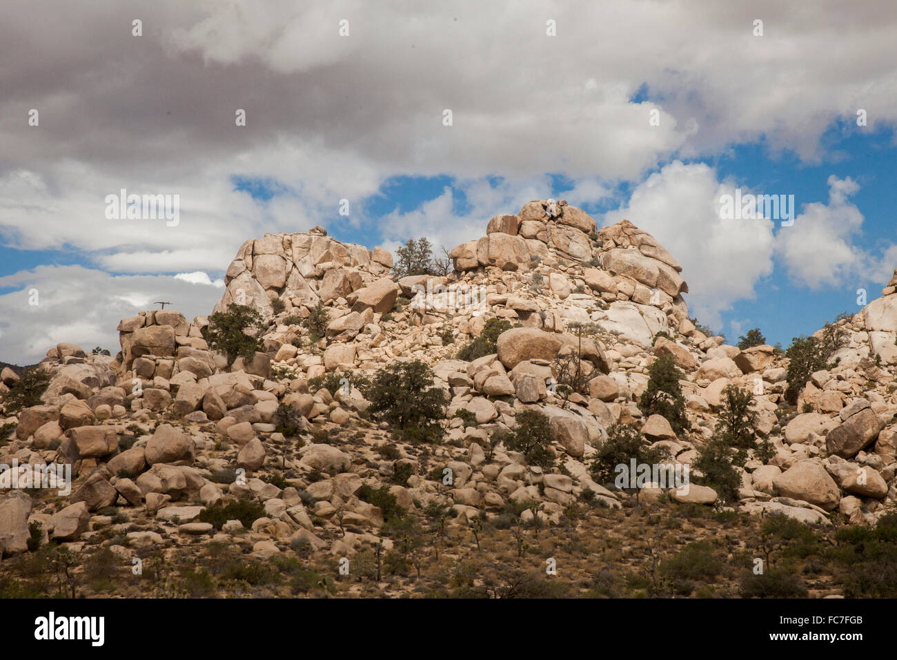 Desert rock formations under cloudy sky Stock Photo - Alamy