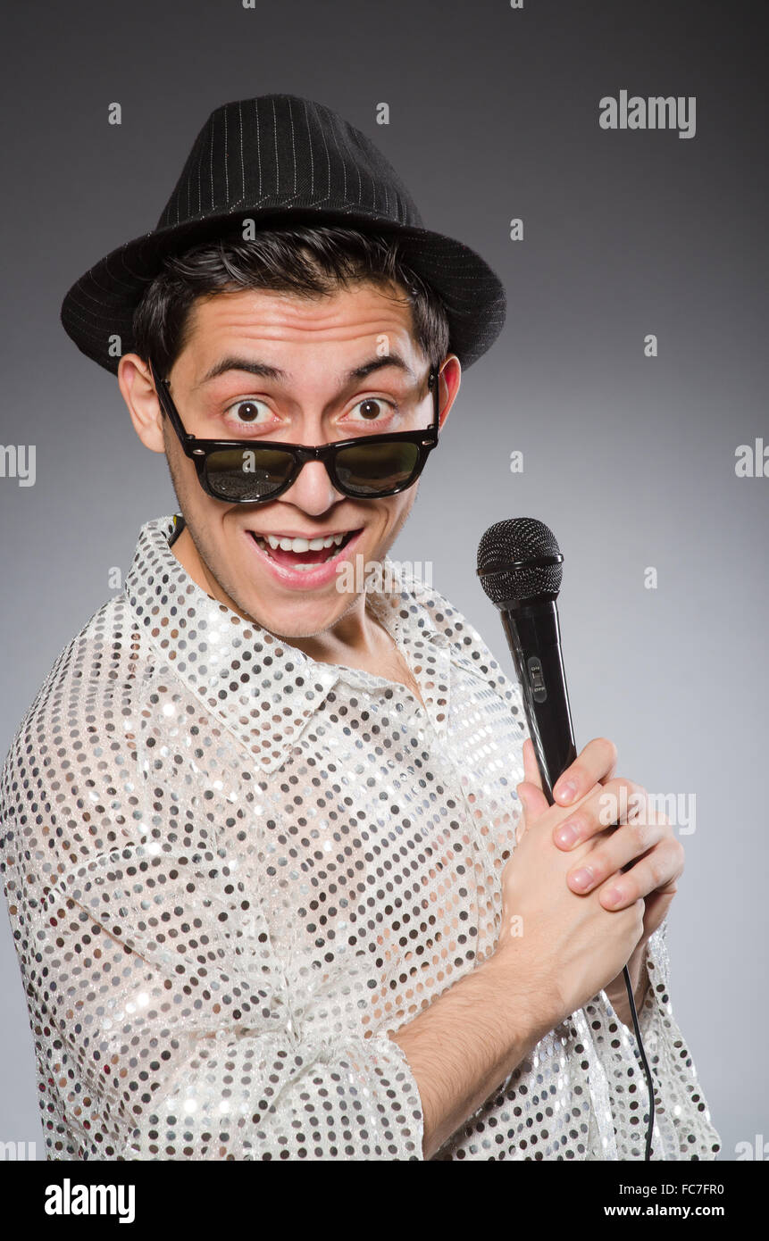 Young singer with microphone isolated on white Stock Photo - Alamy