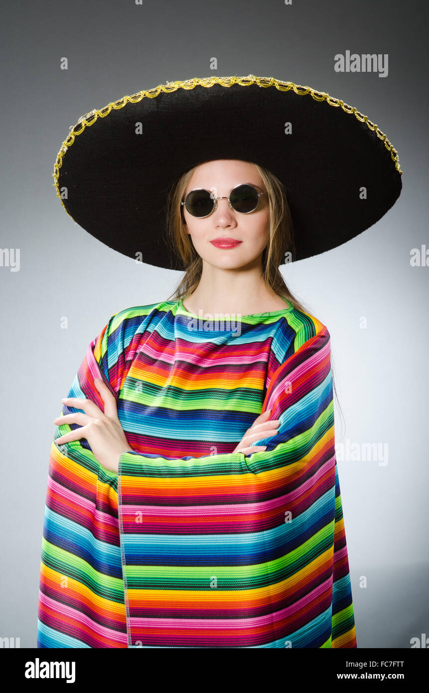 Girl in mexican vivid poncho against gray Stock Photo - Alamy