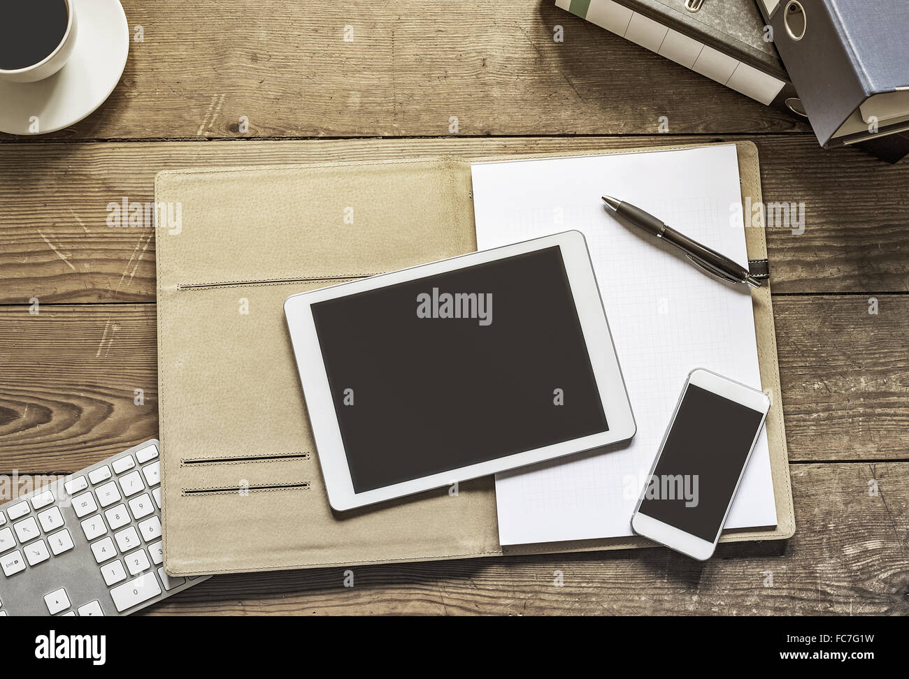 tablet and phone on office folder Stock Photo - Alamy