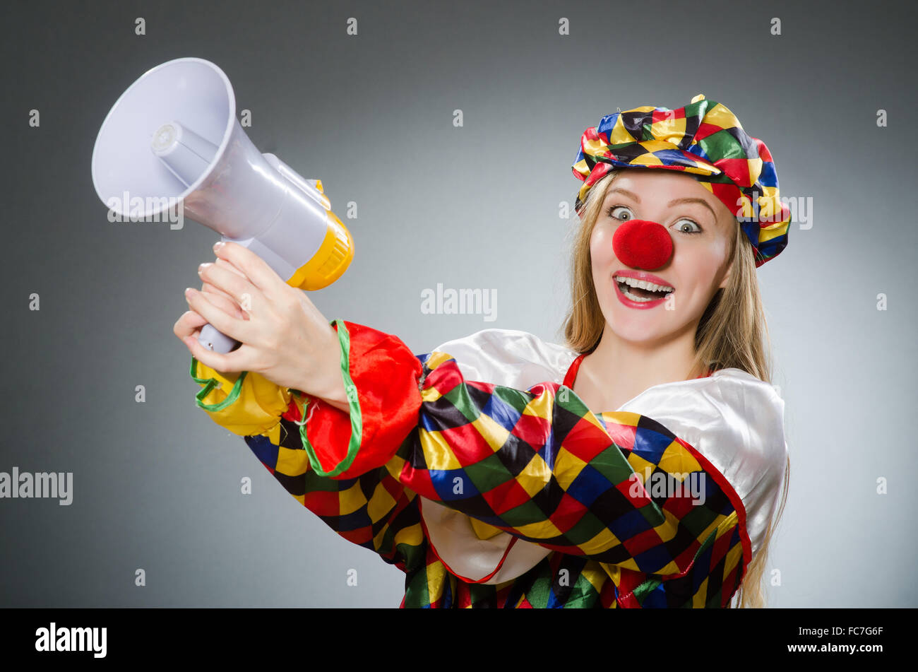 Clown with loudspeaker isolated on white Stock Photo - Alamy