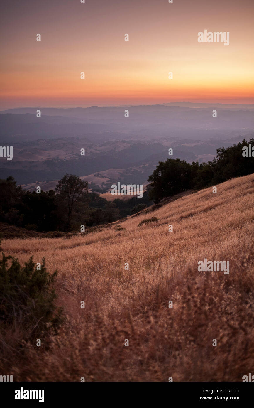 Grassy hillside over remote landscape Stock Photo - Alamy