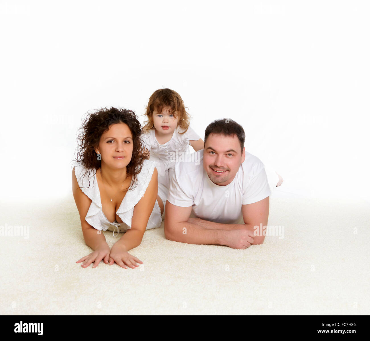 portrait of mother, father and their child together in studio Stock ...