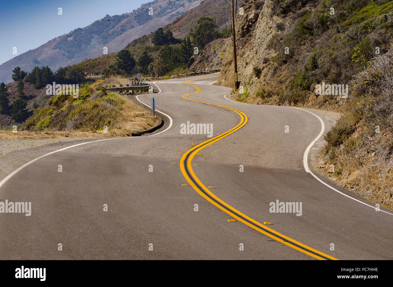 Empty road on remote hillside Stock Photo - Alamy