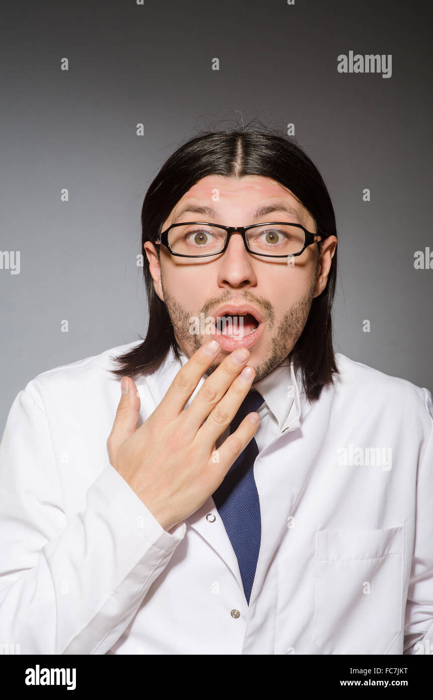 Male doctor against gray Stock Photo - Alamy