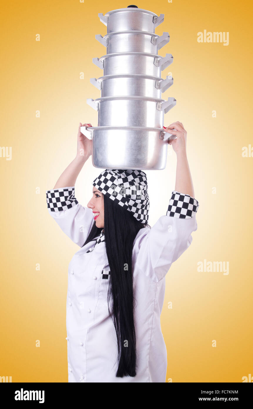 Cook with stack of pots on white Stock Photo - Alamy