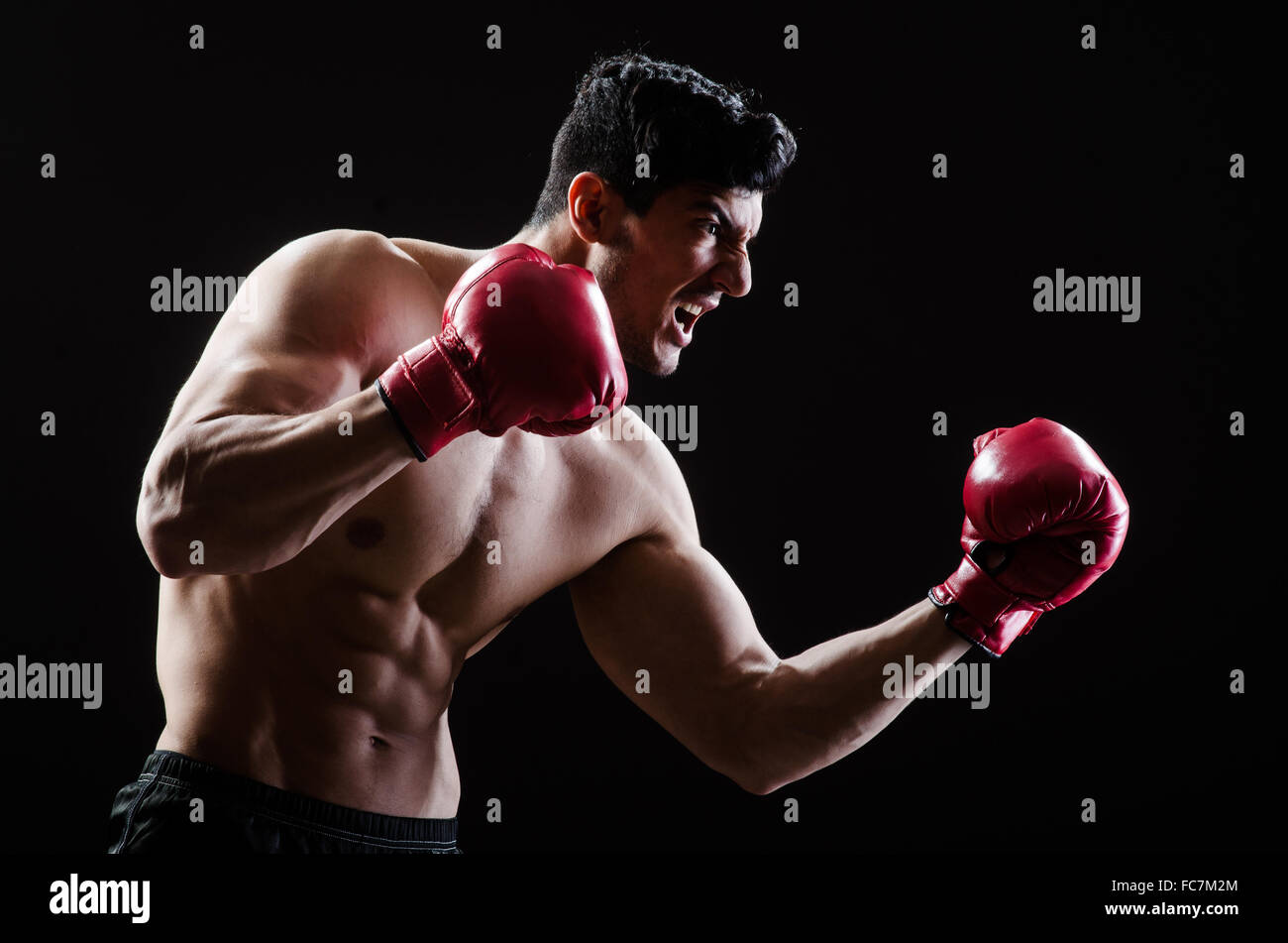 Muscular man in boxing concept Stock Photo - Alamy