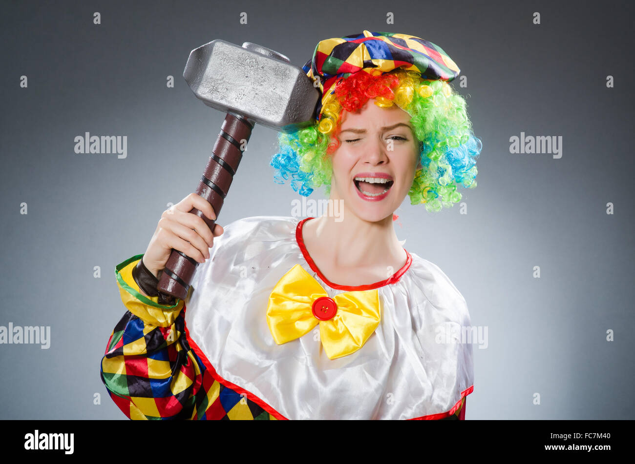 Clown with hammer in funny concept Stock Photo - Alamy