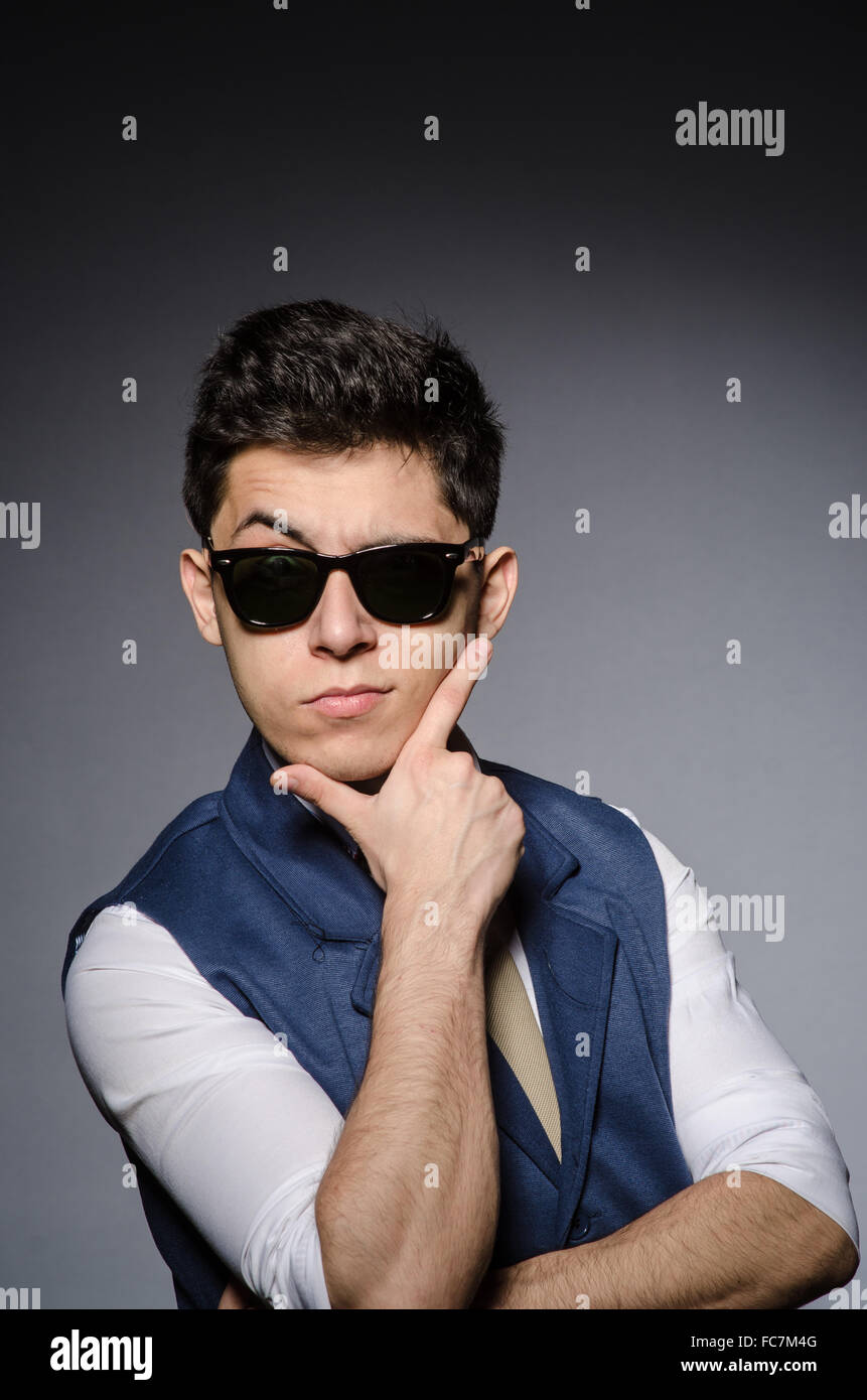 Young man in blue vest against gray Stock Photo - Alamy