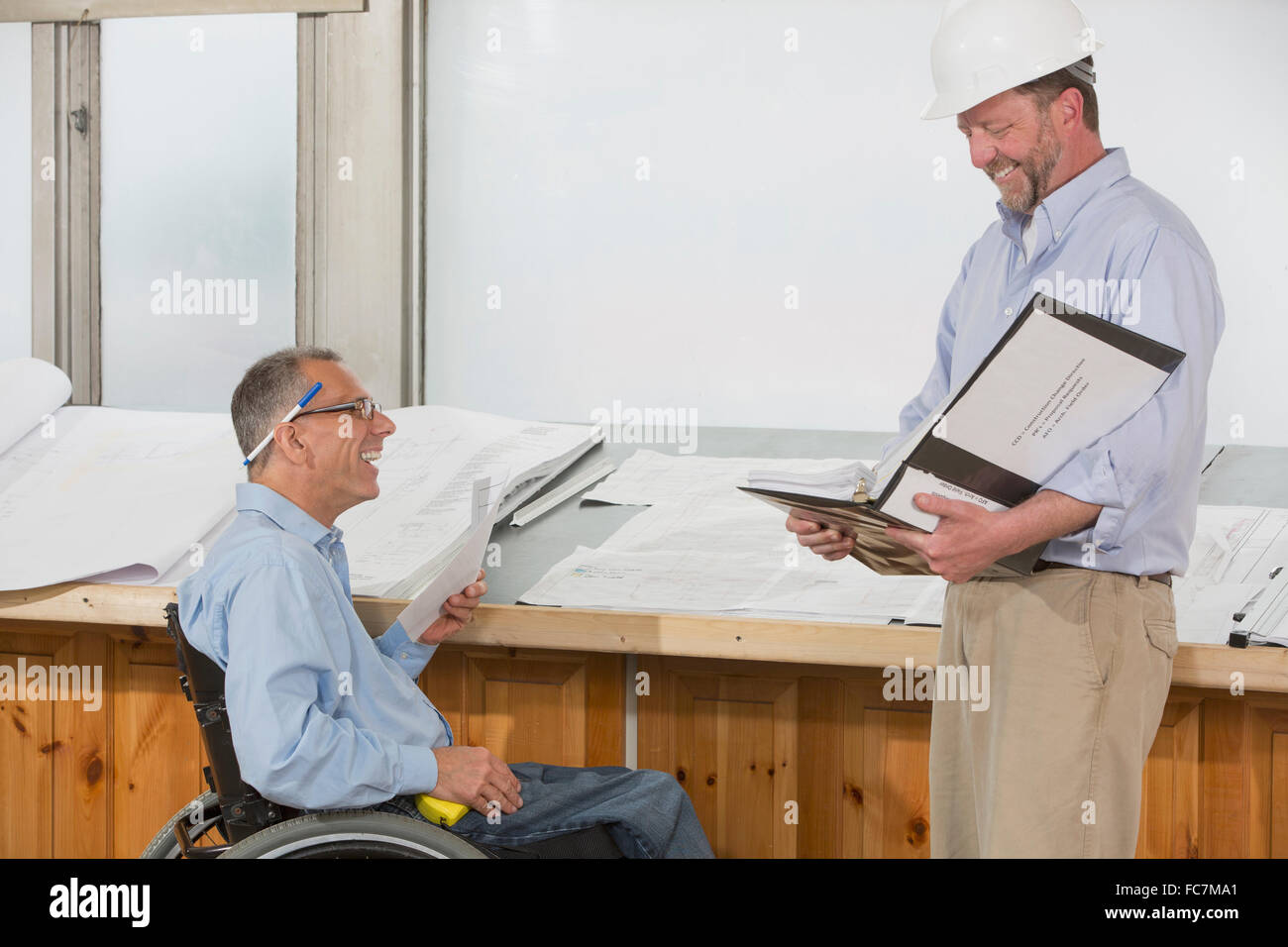 Caucasian architects talking in office Stock Photo - Alamy