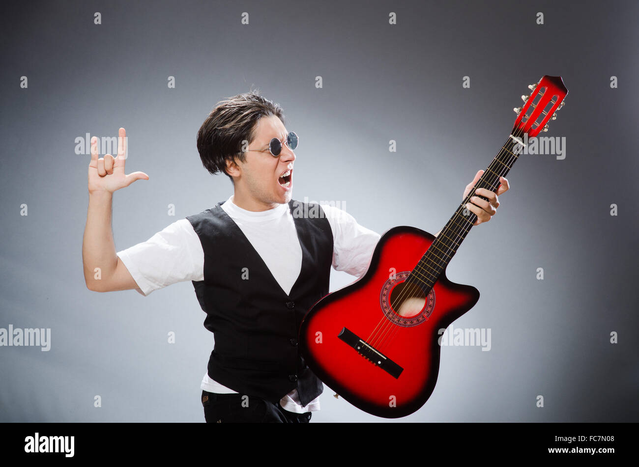 Funny guitar player in musical concept Stock Photo - Alamy