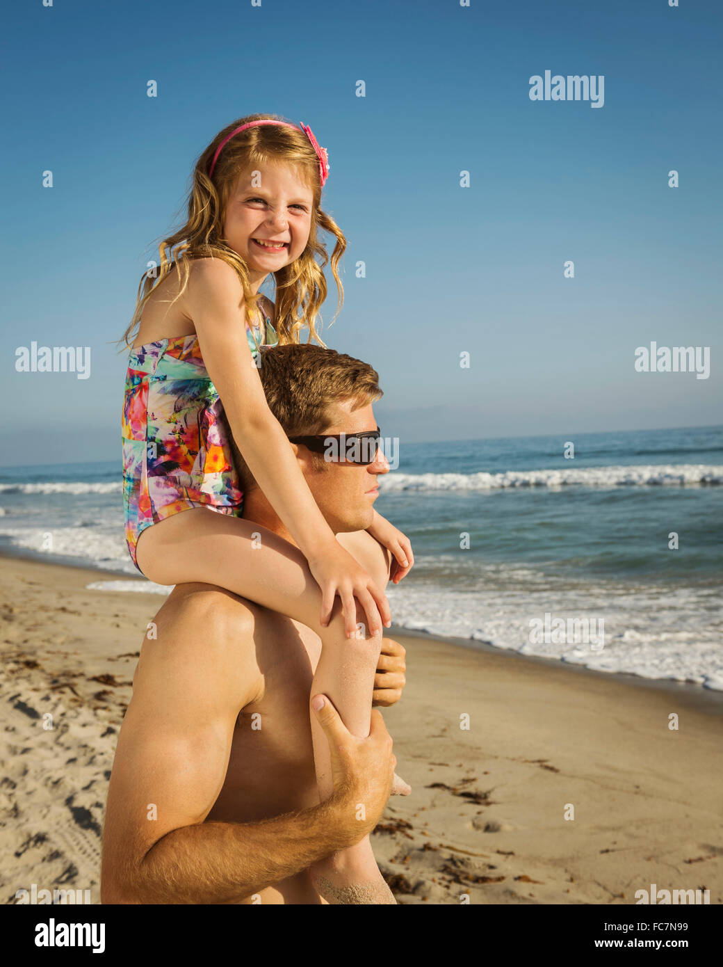Father carrying daughter on the beach hi-res stock photography and images - Alamy