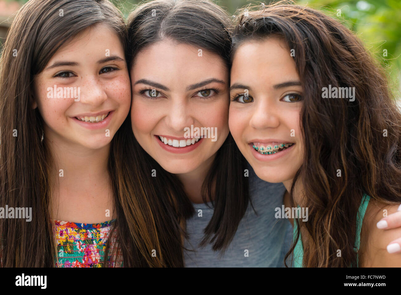 Mother and daughters smiling outdoors Stock Photo - Alamy