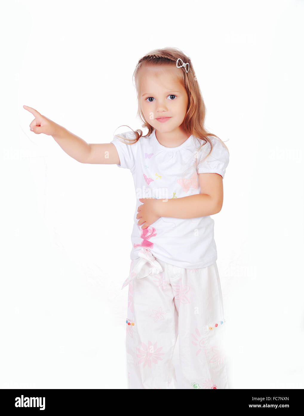 The little girl on a white background and pointing in the direction ...