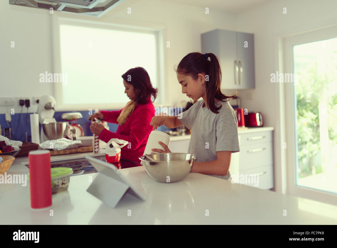 Mother and daughter cooking in kitchen Stock Photo - Alamy