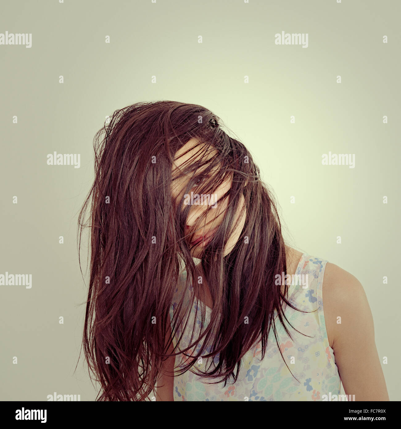 Mixed race girl tossing her hair Stock Photo - Alamy