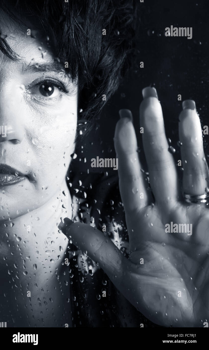 Woman behind glass hi-res stock photography and images - Alamy