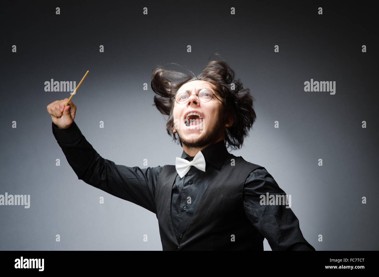 Funny conductor in musical concept Stock Photo - Alamy