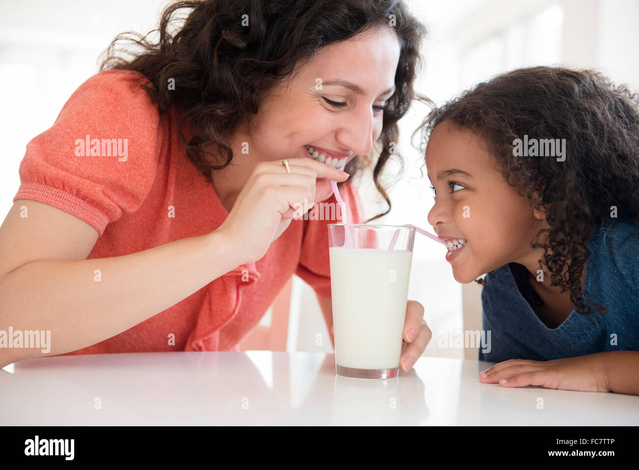 Mother and daughter drinking milk Stock Photo - Alamy