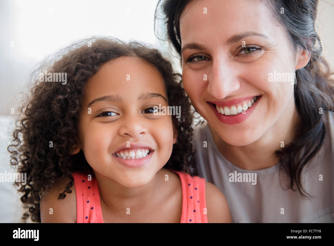 Mother and daughter smiling Stock Photo - Alamy