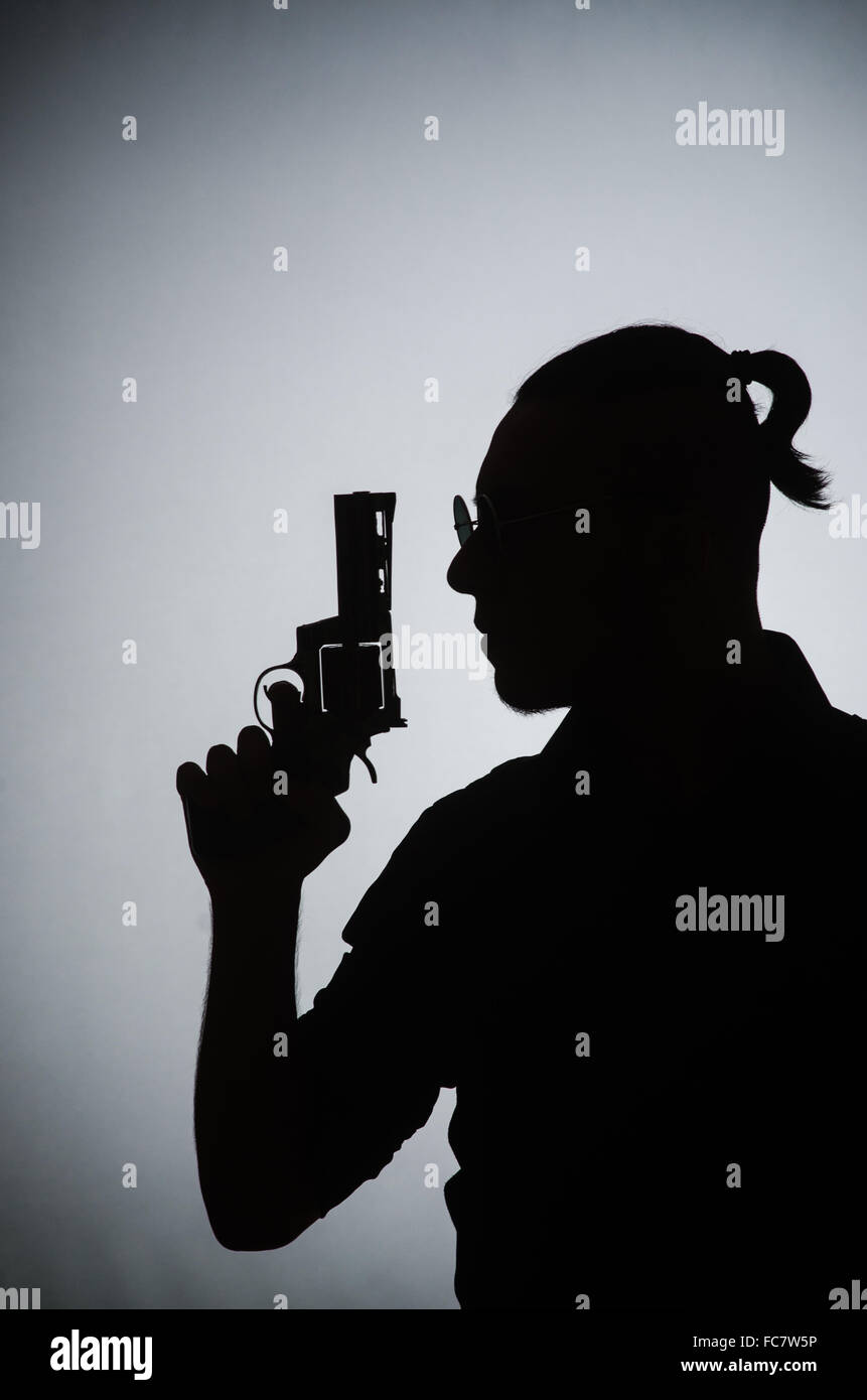 Shadow of the man with gun Stock Photo - Alamy