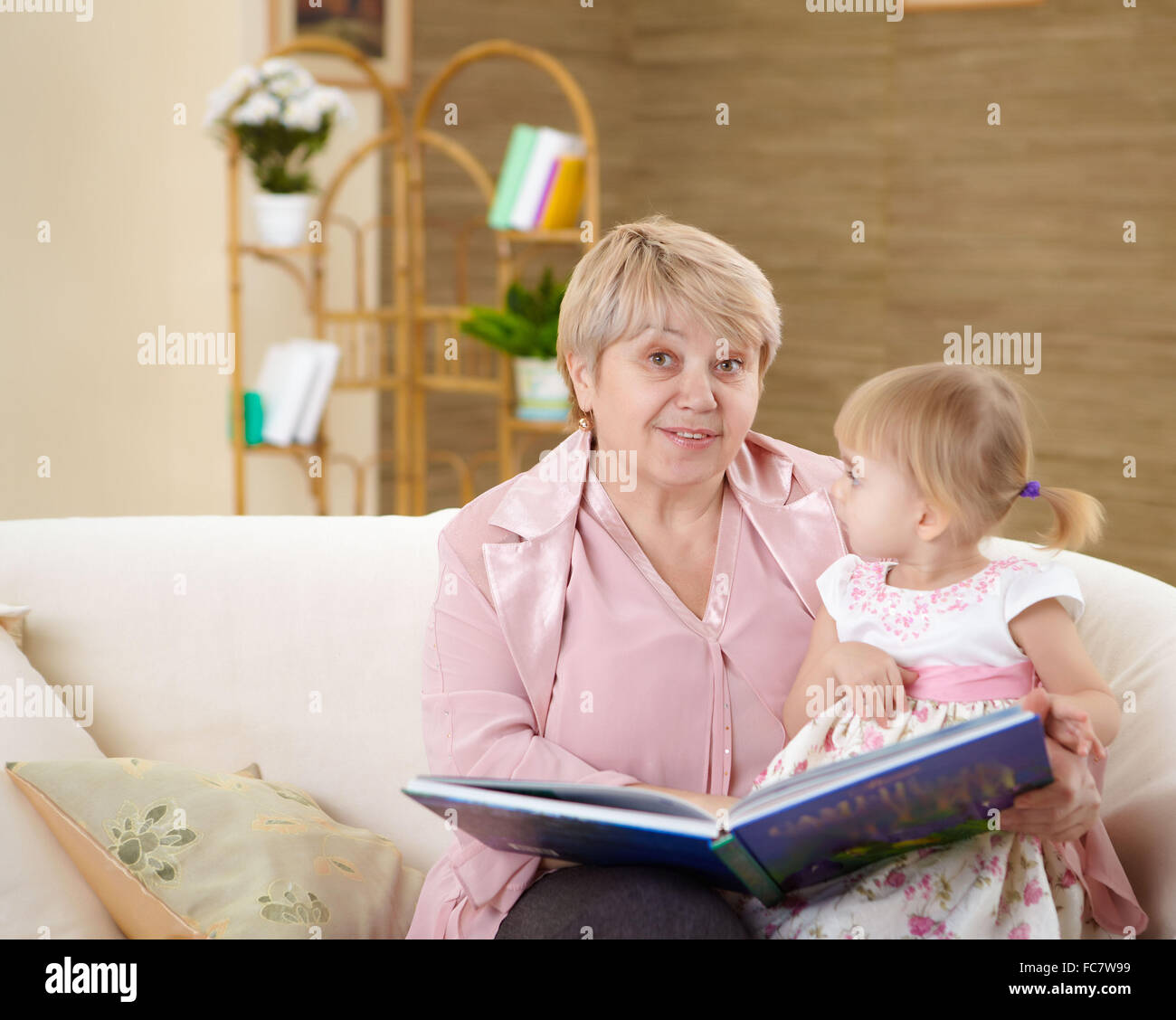 Grandmother reading book holding cute hi-res stock photography and ...