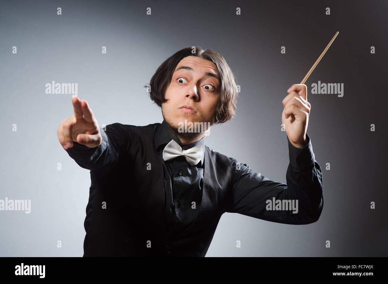 Funny conductor in musical concept Stock Photo - Alamy