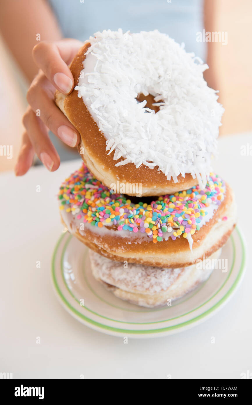 Hispanic woman choosing donut Stock Photo - Alamy