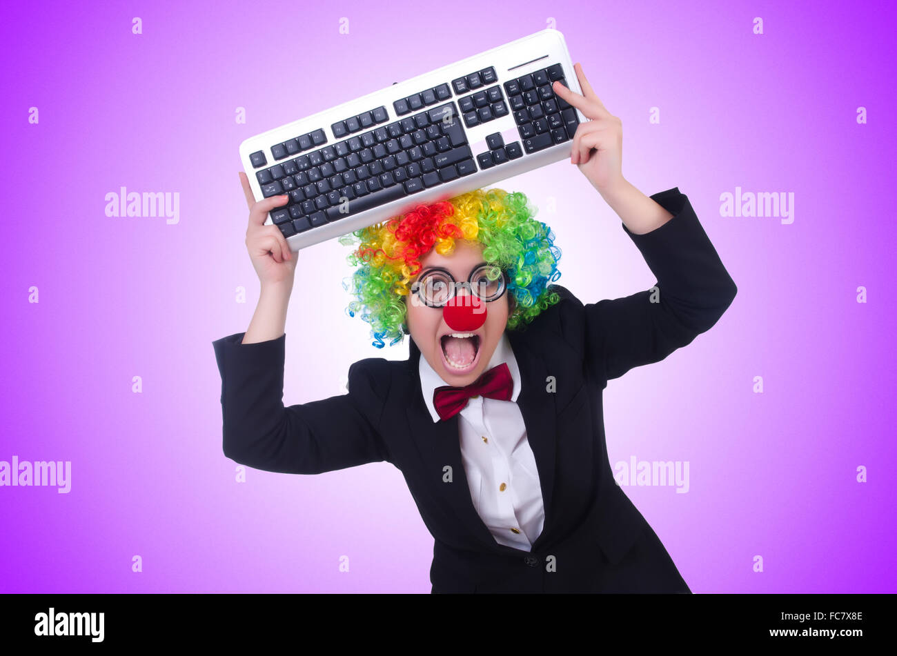 Funny clown with keyboard on white Stock Photo - Alamy