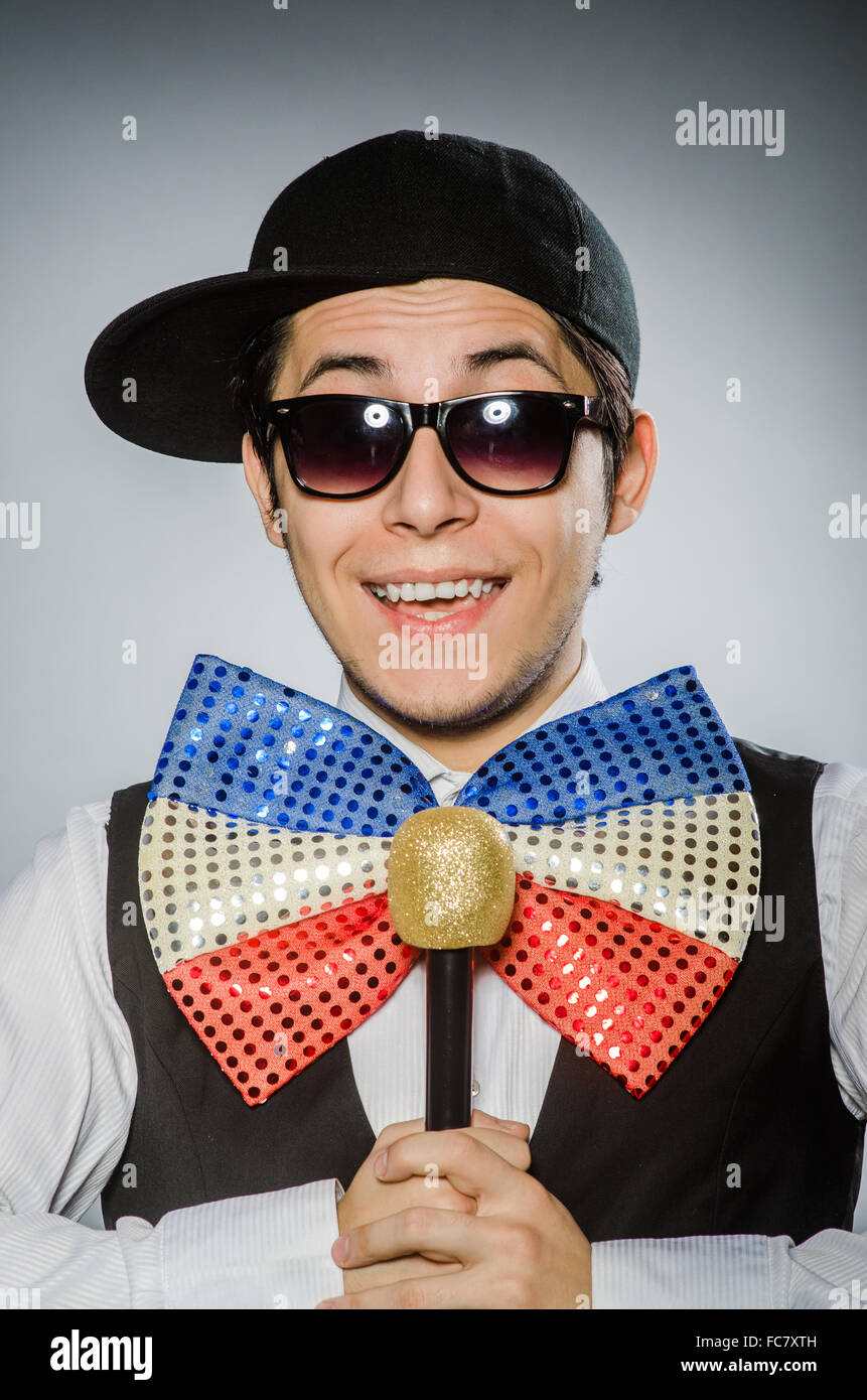 Funny man with mic in karaoke concept Stock Photo - Alamy
