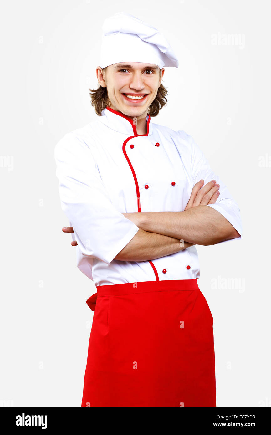 Portrait of a young cook in uniform preparing meal Stock Photo - Alamy