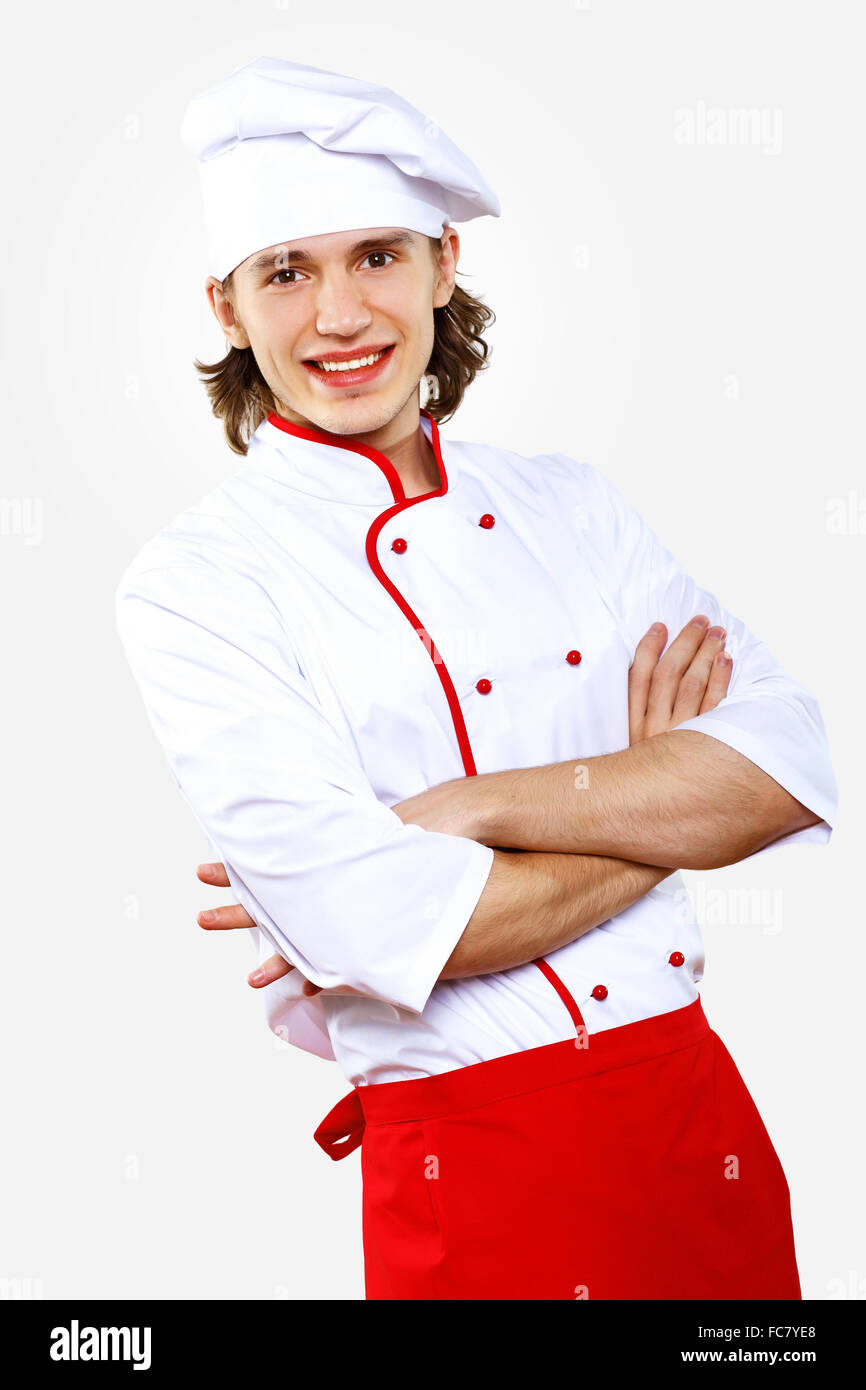 Portrait of a young cook in uniform preparing meal Stock Photo - Alamy