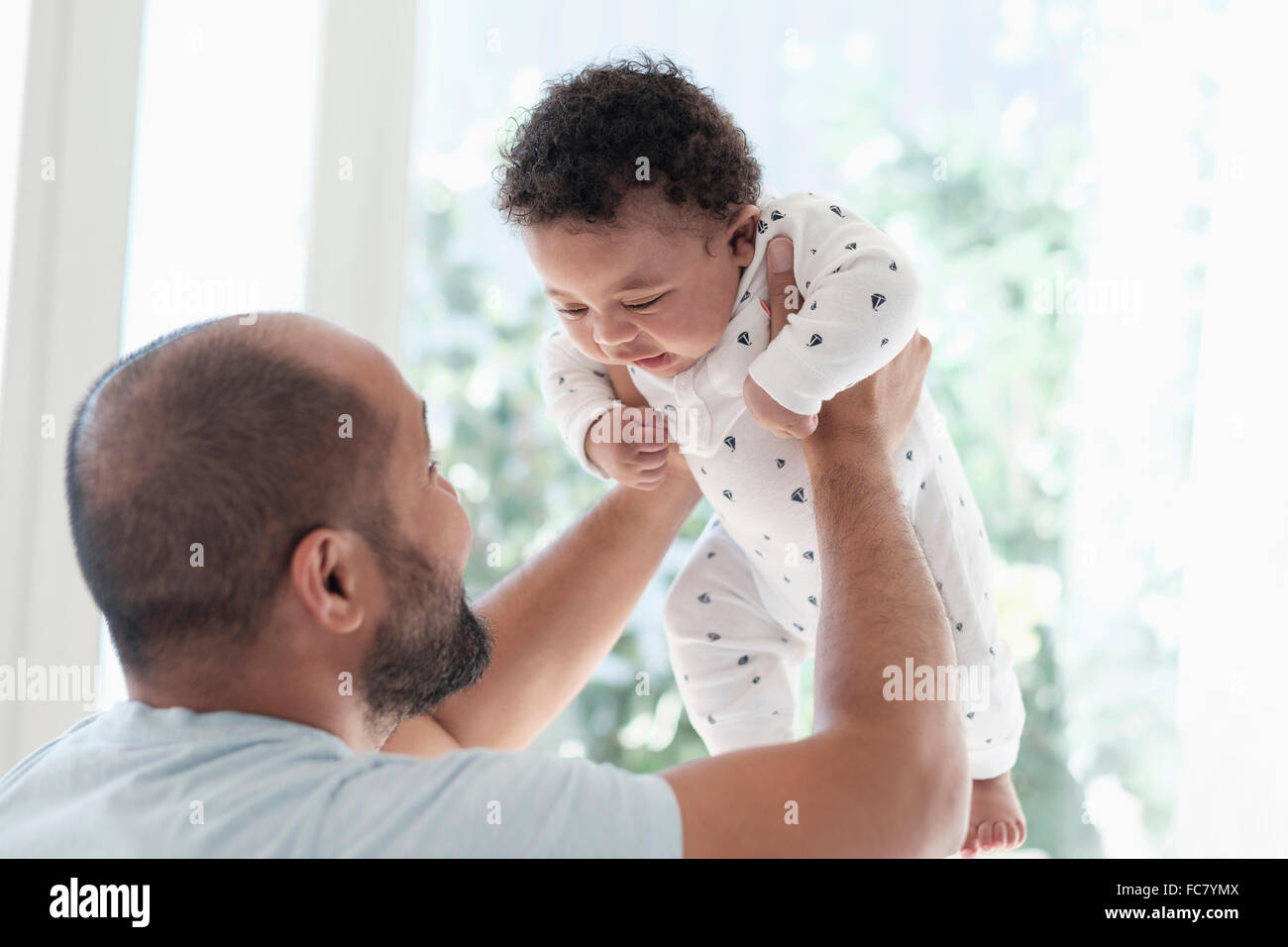 Father playing with baby son Stock Photo - Alamy