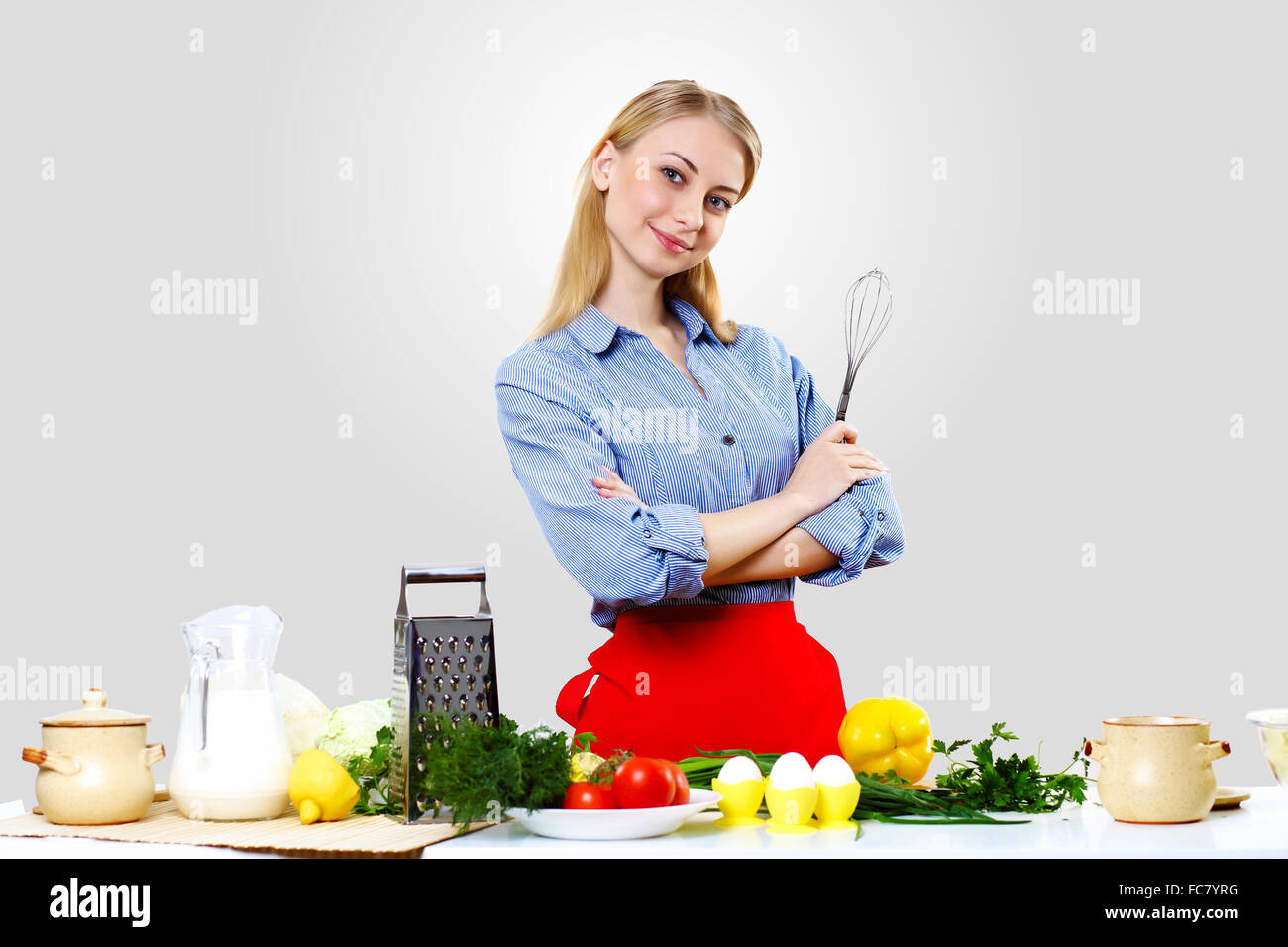 Young happy woman cooking fresh meal at home Stock Photo - Alamy