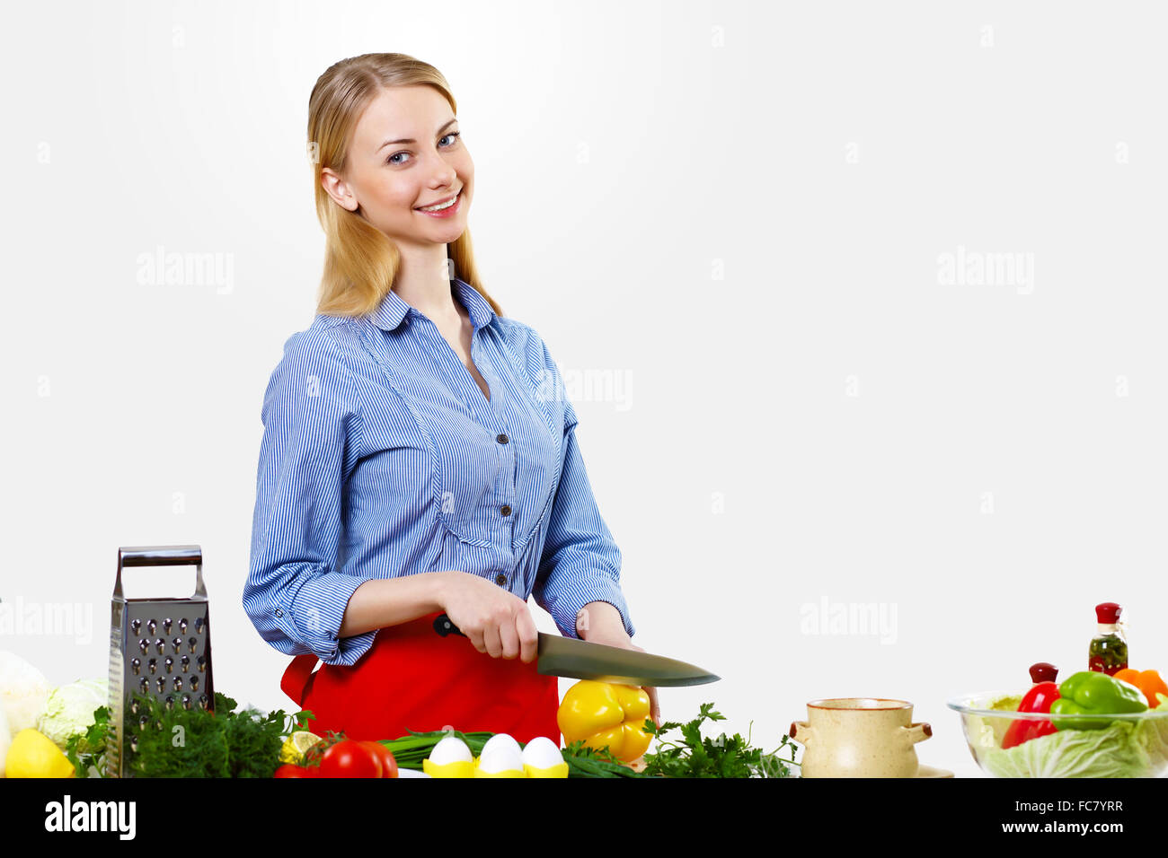 Young happy woman cooking fresh meal at home Stock Photo - Alamy
