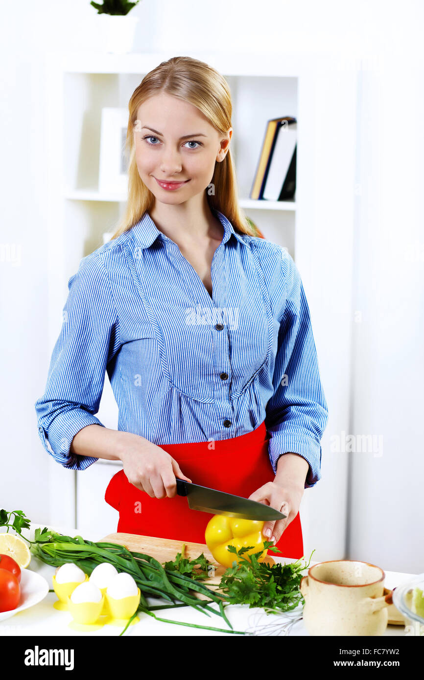 Young happy woman cooking fresh meal at home Stock Photo - Alamy