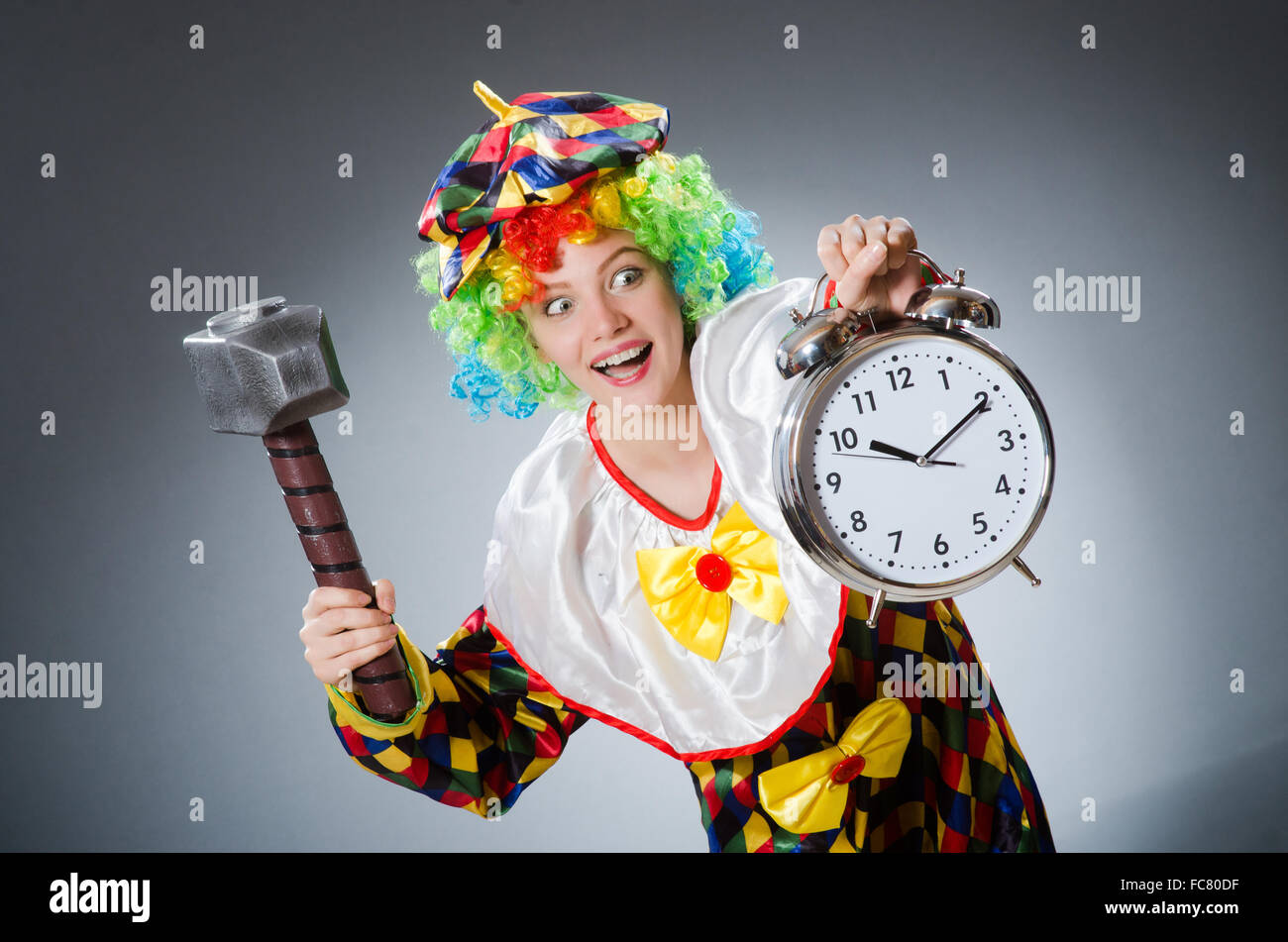 Clown with hammer and clock Stock Photo - Alamy