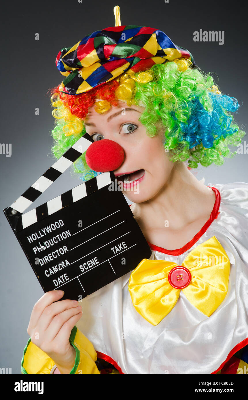 Clown with movie clapper in funny concept Stock Photo - Alamy