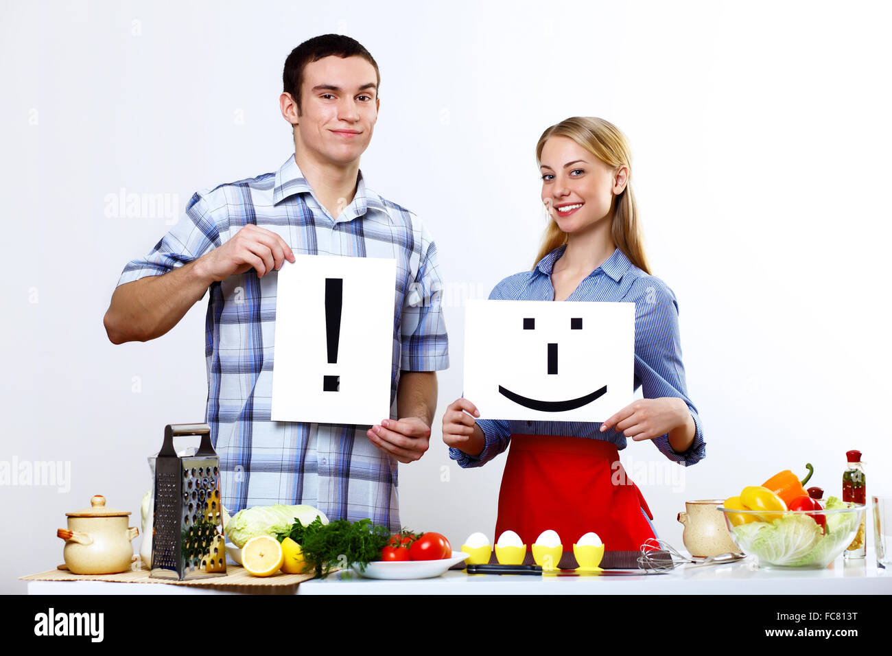 Happy husband and wife cooking together at home Stock Photo - Alamy