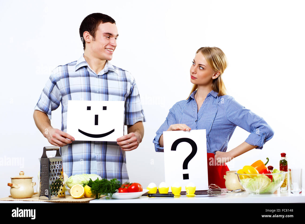 Happy husband and wife cooking together at home Stock Photo - Alamy
