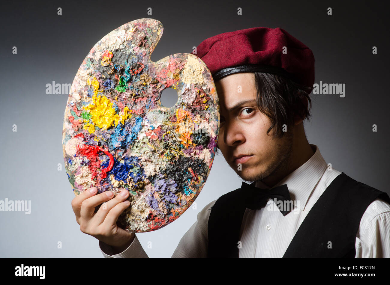 Funny artist in dark studio Stock Photo - Alamy